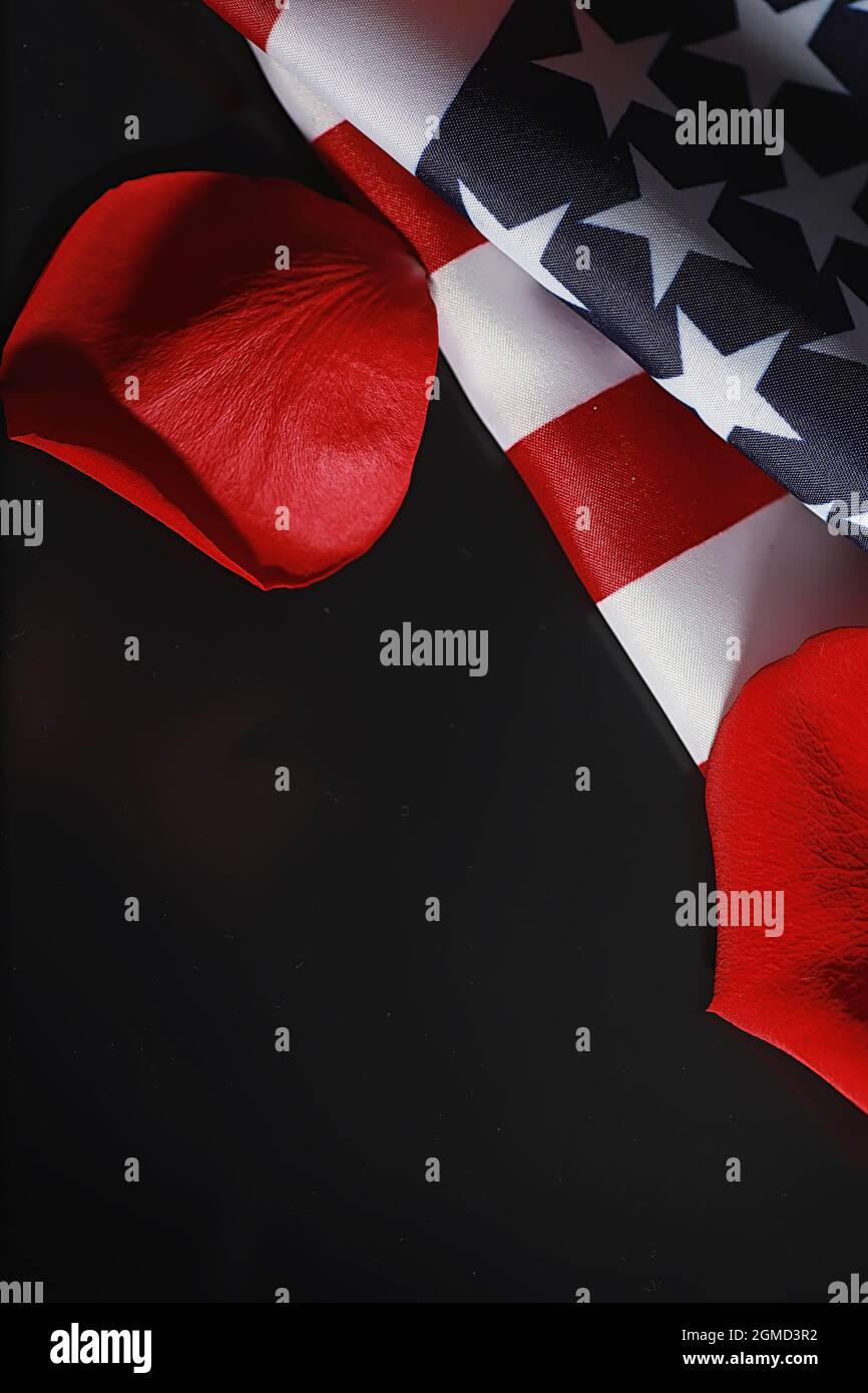 American flag and rose flower on table. Symbol of the United States of ...