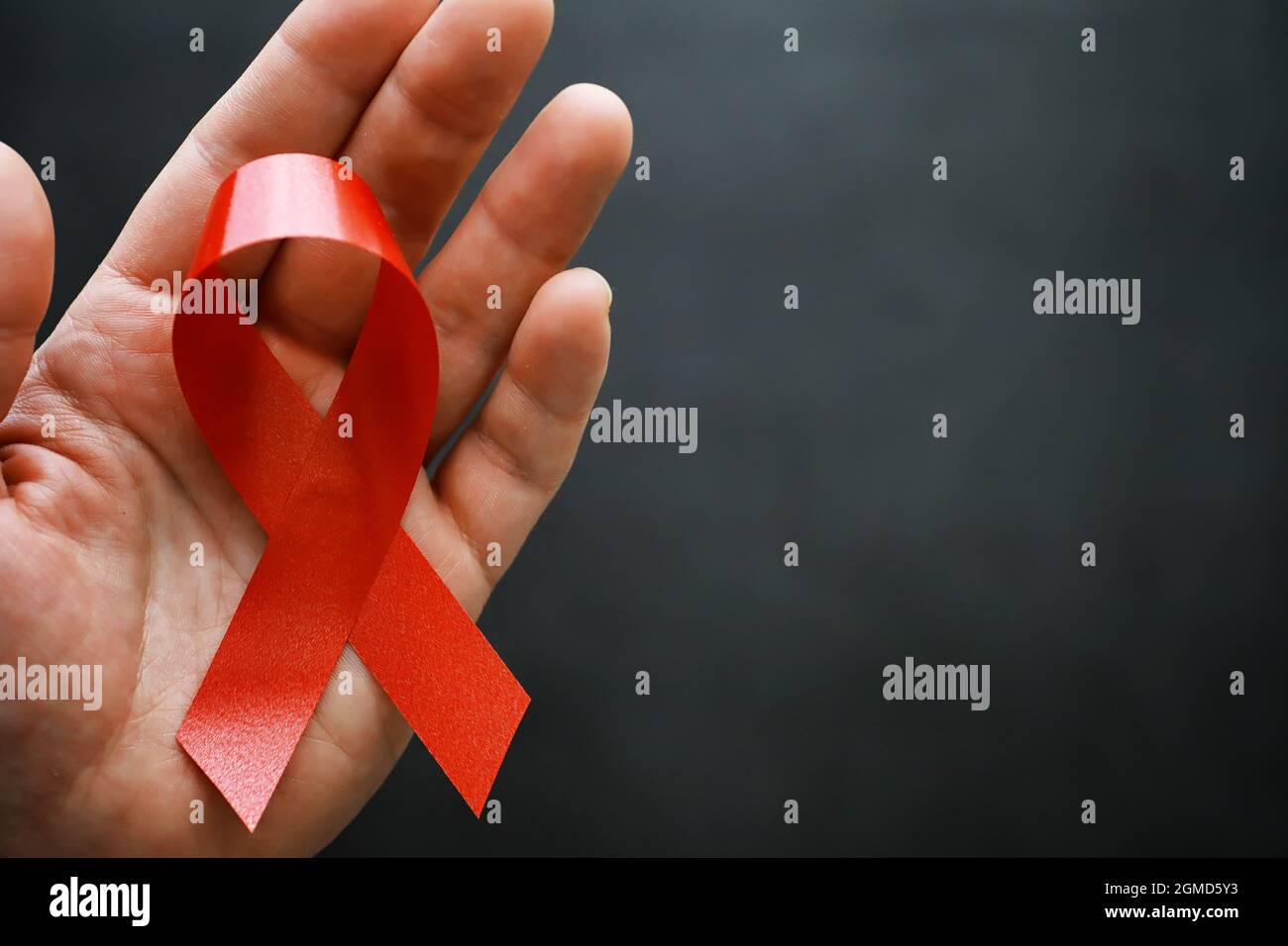 Symbol of human immunodeficiency virus disease. Red ribbon. A helping ...