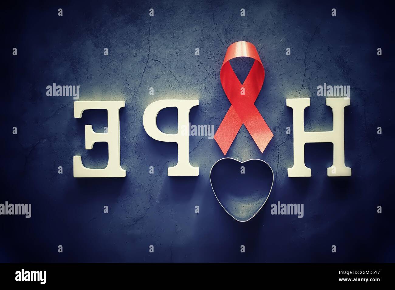 Symbol of human immunodeficiency virus disease. Red ribbon. A helping ...