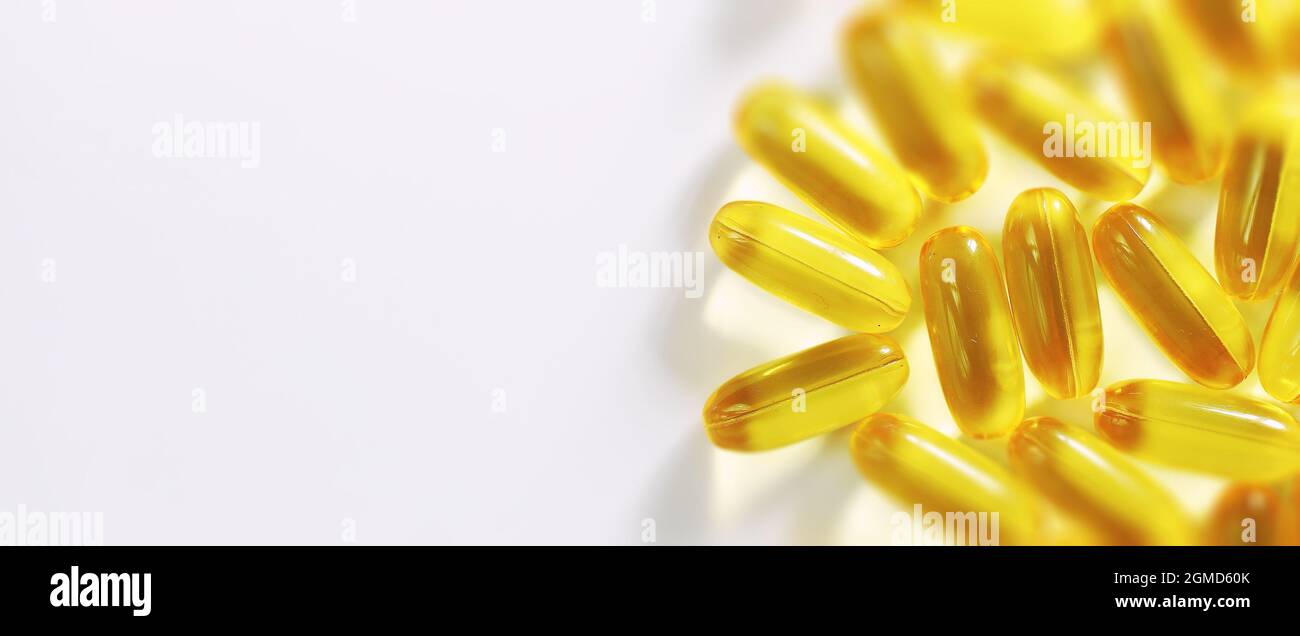 Medical medicines and supplements transparent capsules of yellow color ...