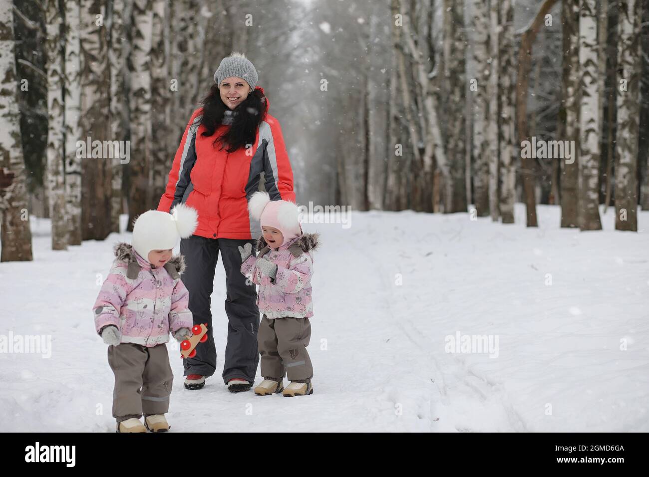 Children walk in the park in winter. Winter forest family with children ...