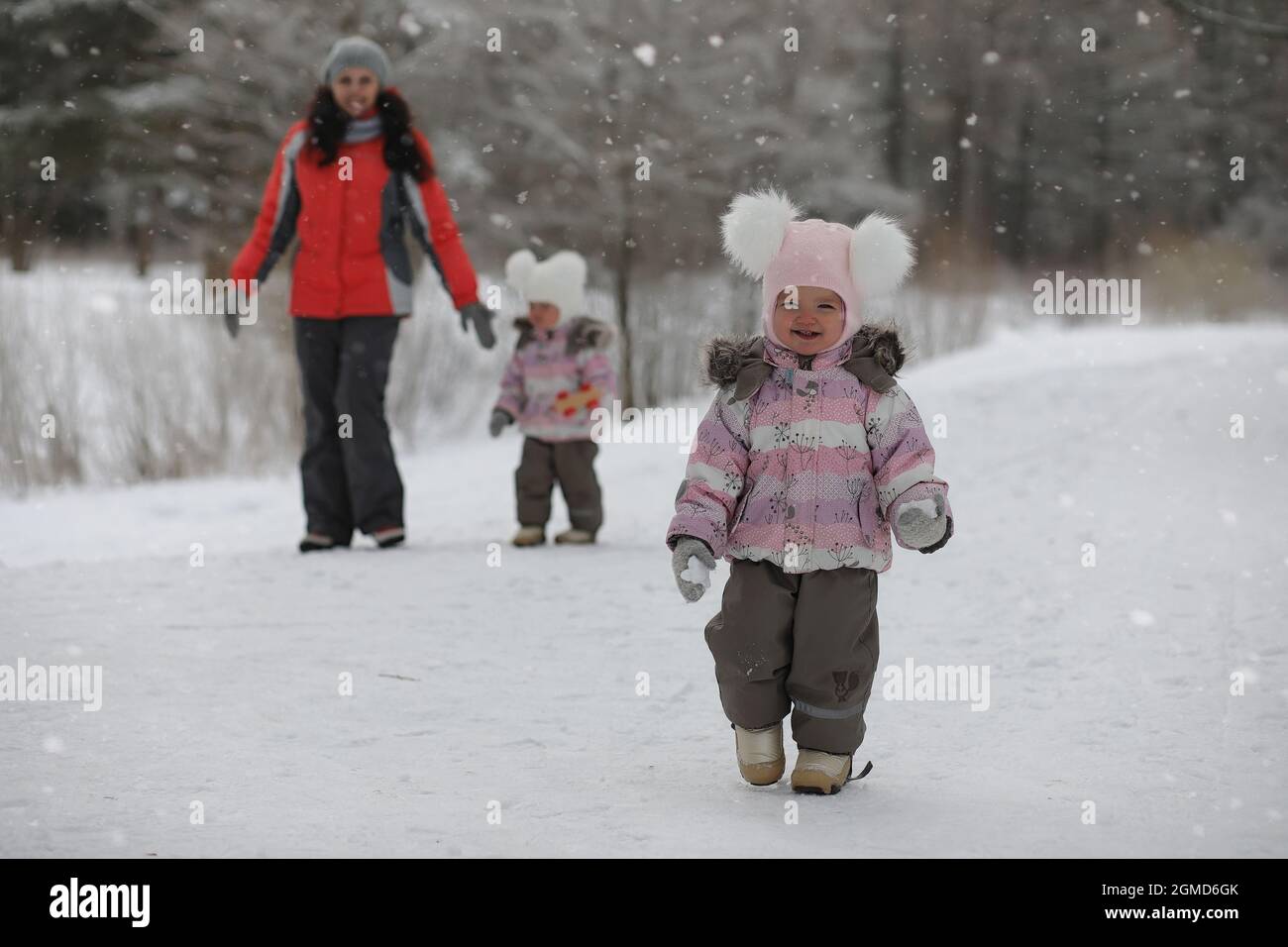 Children walk in the park in winter. Winter forest family with children ...