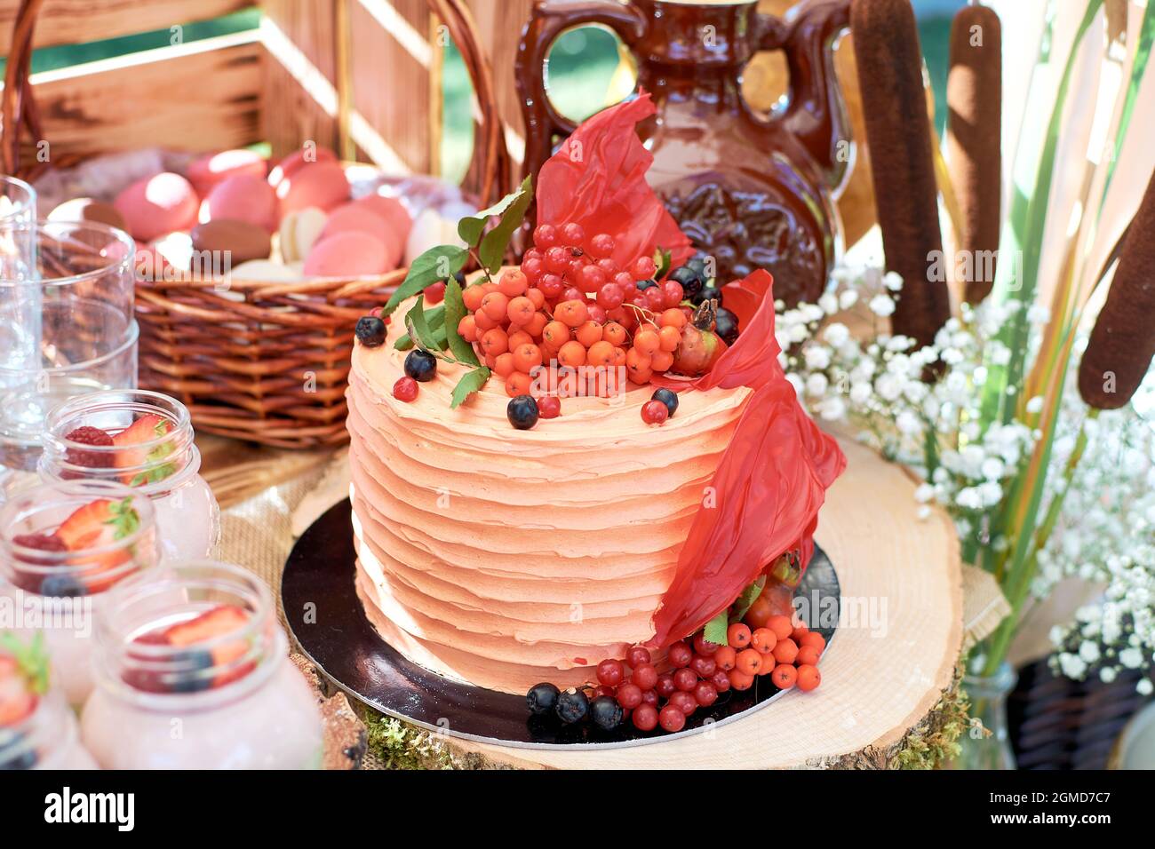 Autumn cake. Orange cake decorated with rowan berries, currants and ...