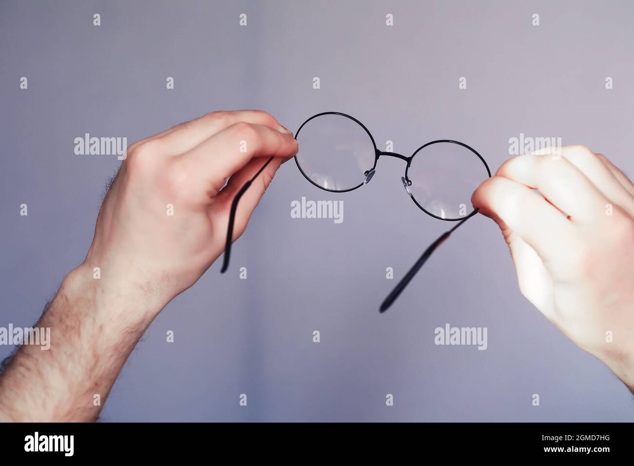The concept of poor vision. Hold a contact lens and glasses in hand ...
