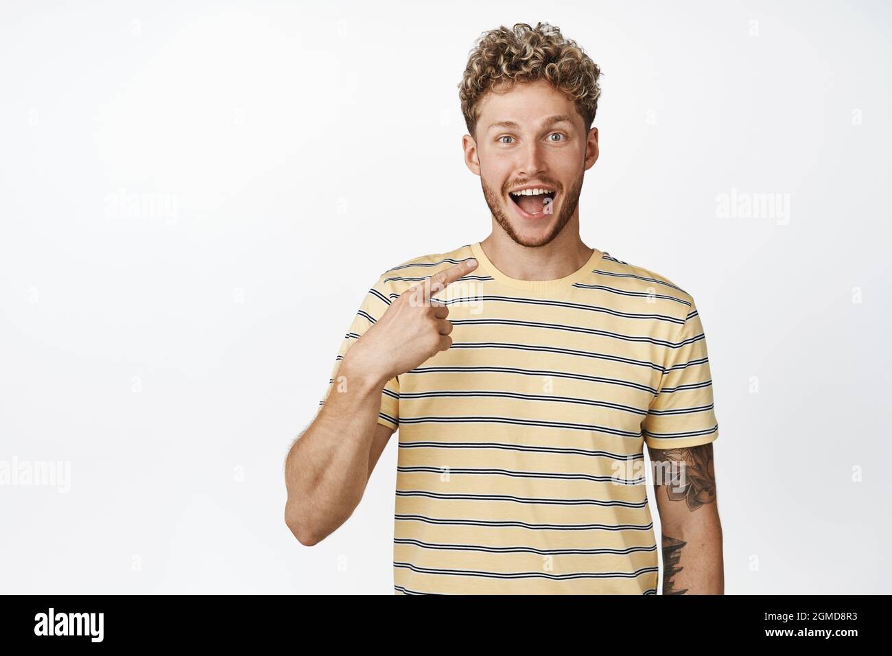Image of happy blond guy pointing at himself and smiling surprised ...