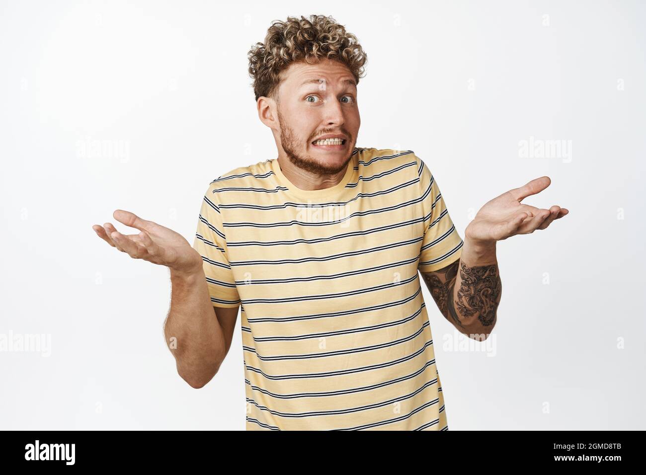 Image of awkward handsome blond guy shrugging shoulders and saying ...