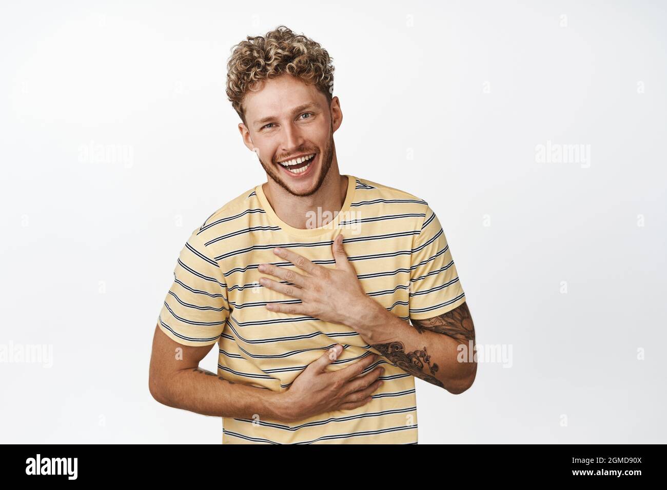 Happy candid blond man, laughing and smiling, chuckle over something ...