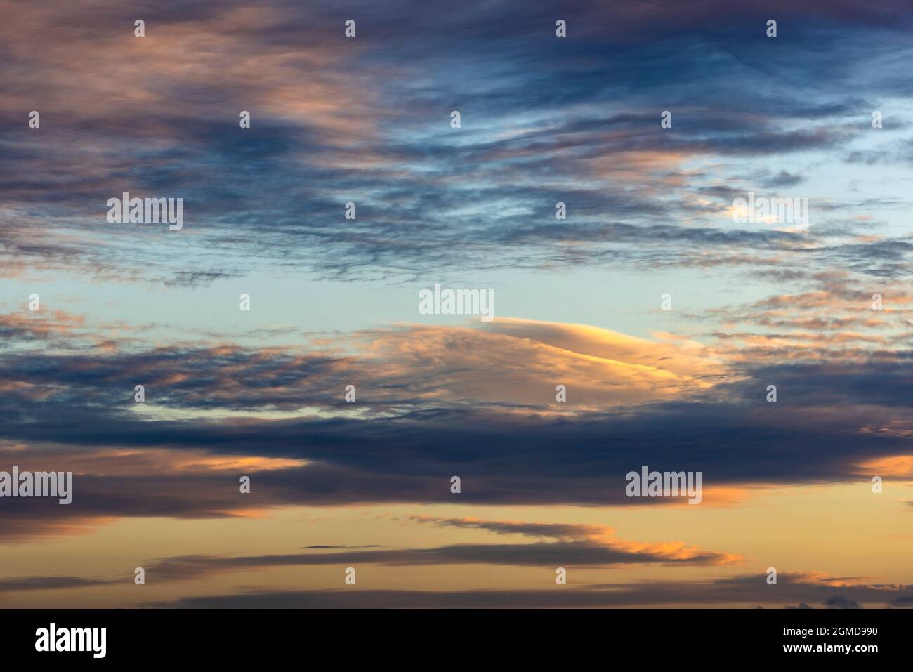 The setting sun lighting up the cloud cover Stock Photo - Alamy