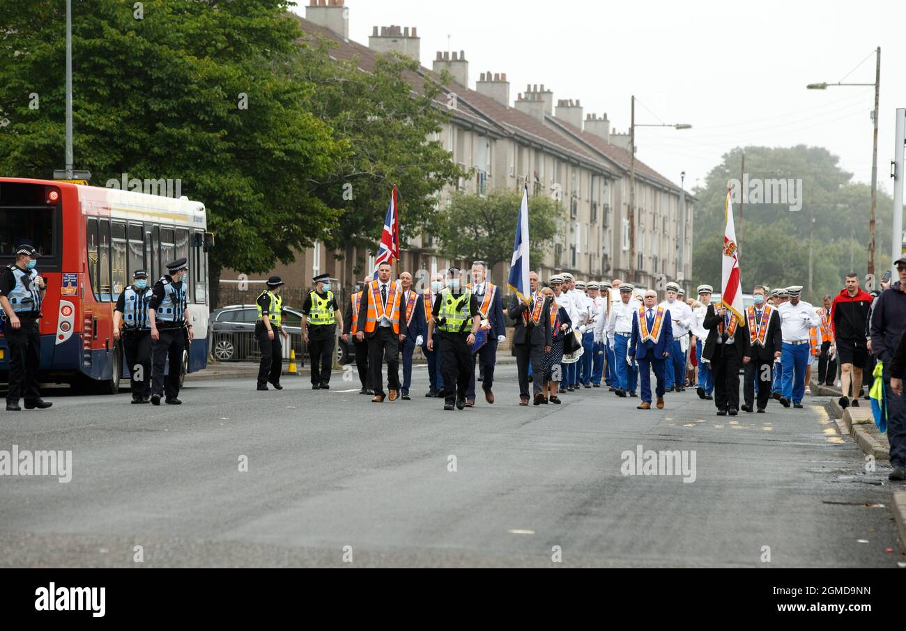 A silent Orange Order band marches through the streets of Easterhouse ...
