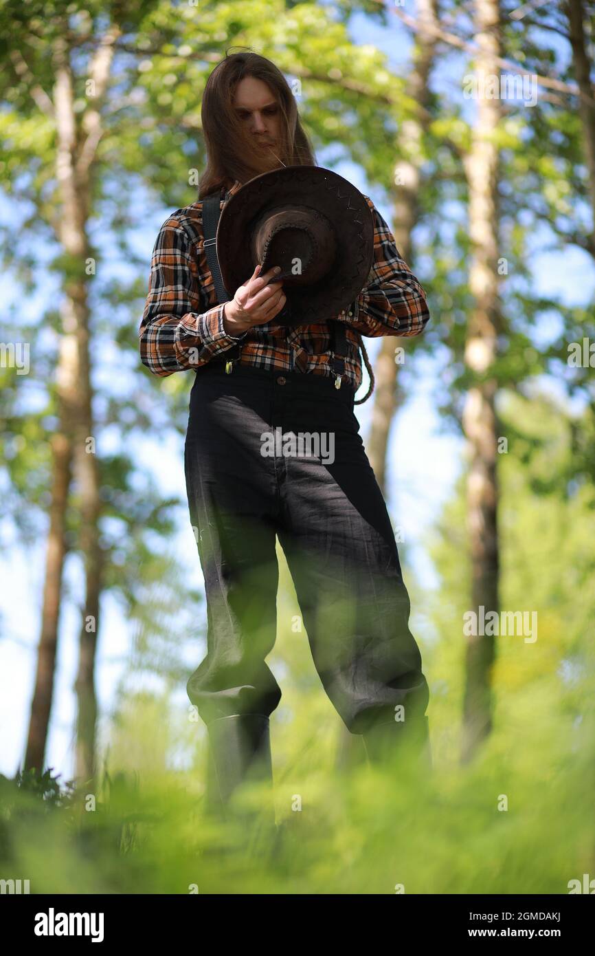 Cowboy with hat in a field in autumn Stock Photo - Alamy