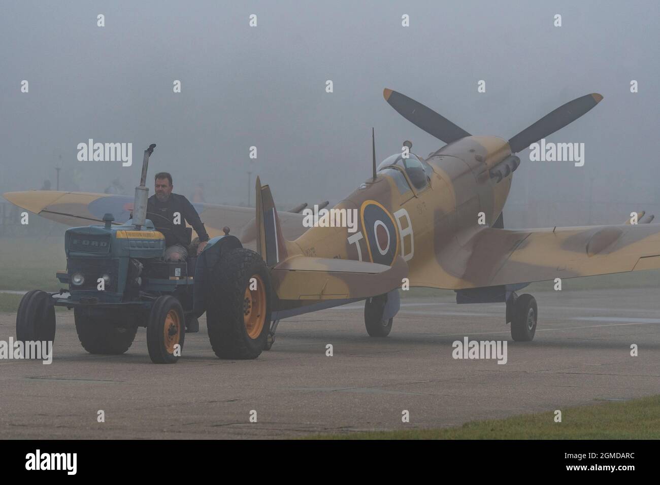 London, UK. 18th Sep, 2021. A Spitfire is towed out to a misty flight ...