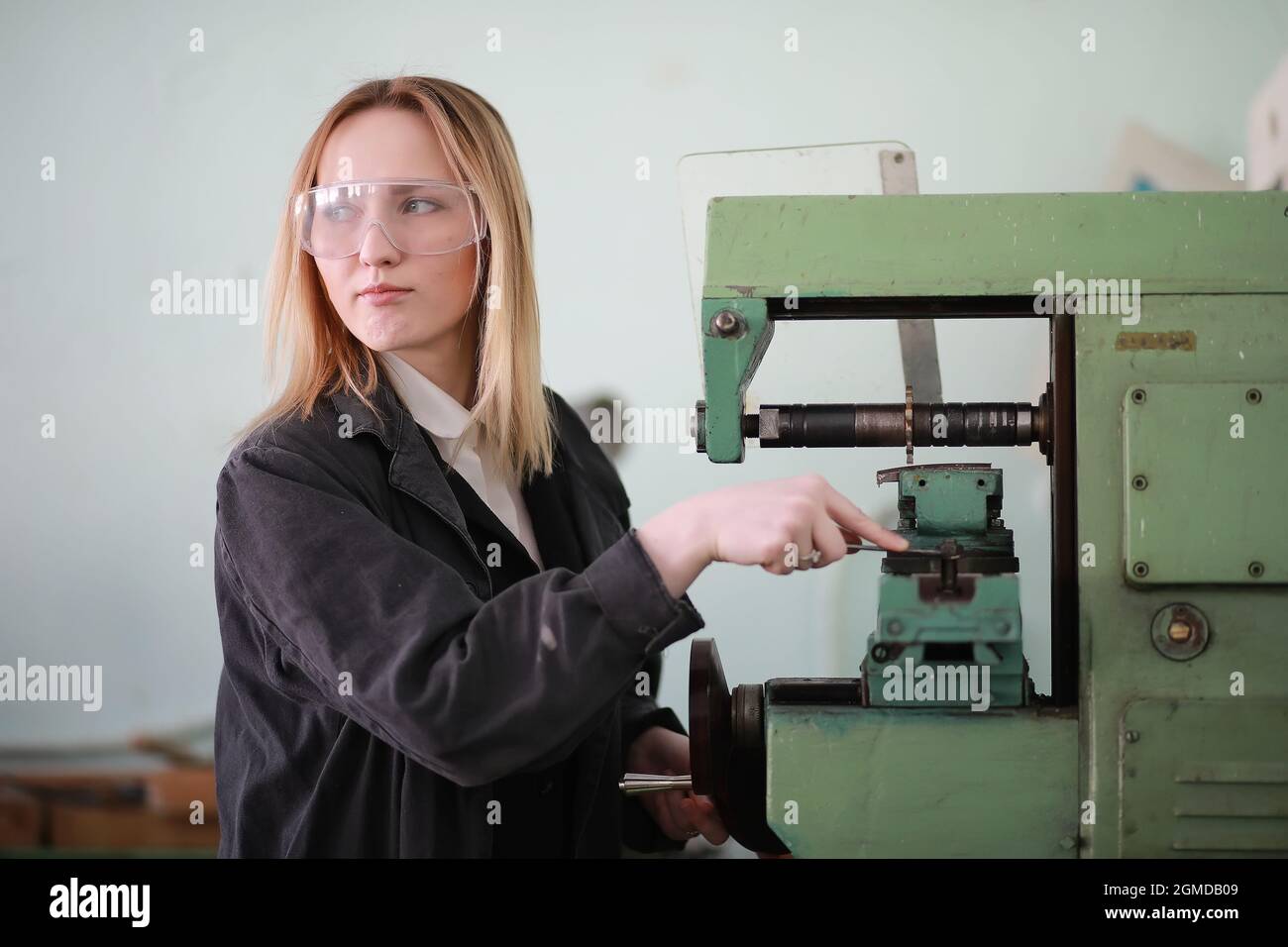 Young woman engineer working at machine tool manufacturing Stock Photo ...