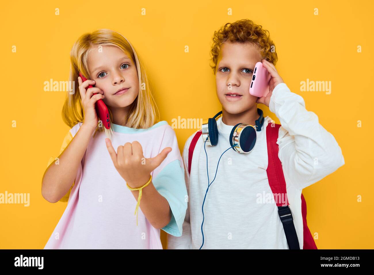 teenage boy and girl use gadgets with headphones isolated background ...