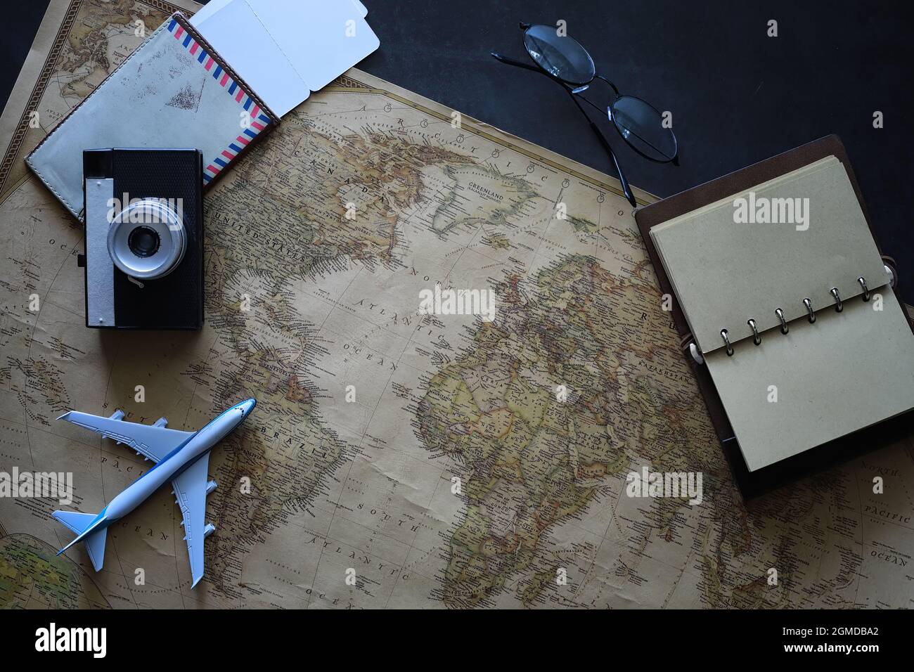 Travel concept. Map on the table and model aircraft Stock Photo - Alamy