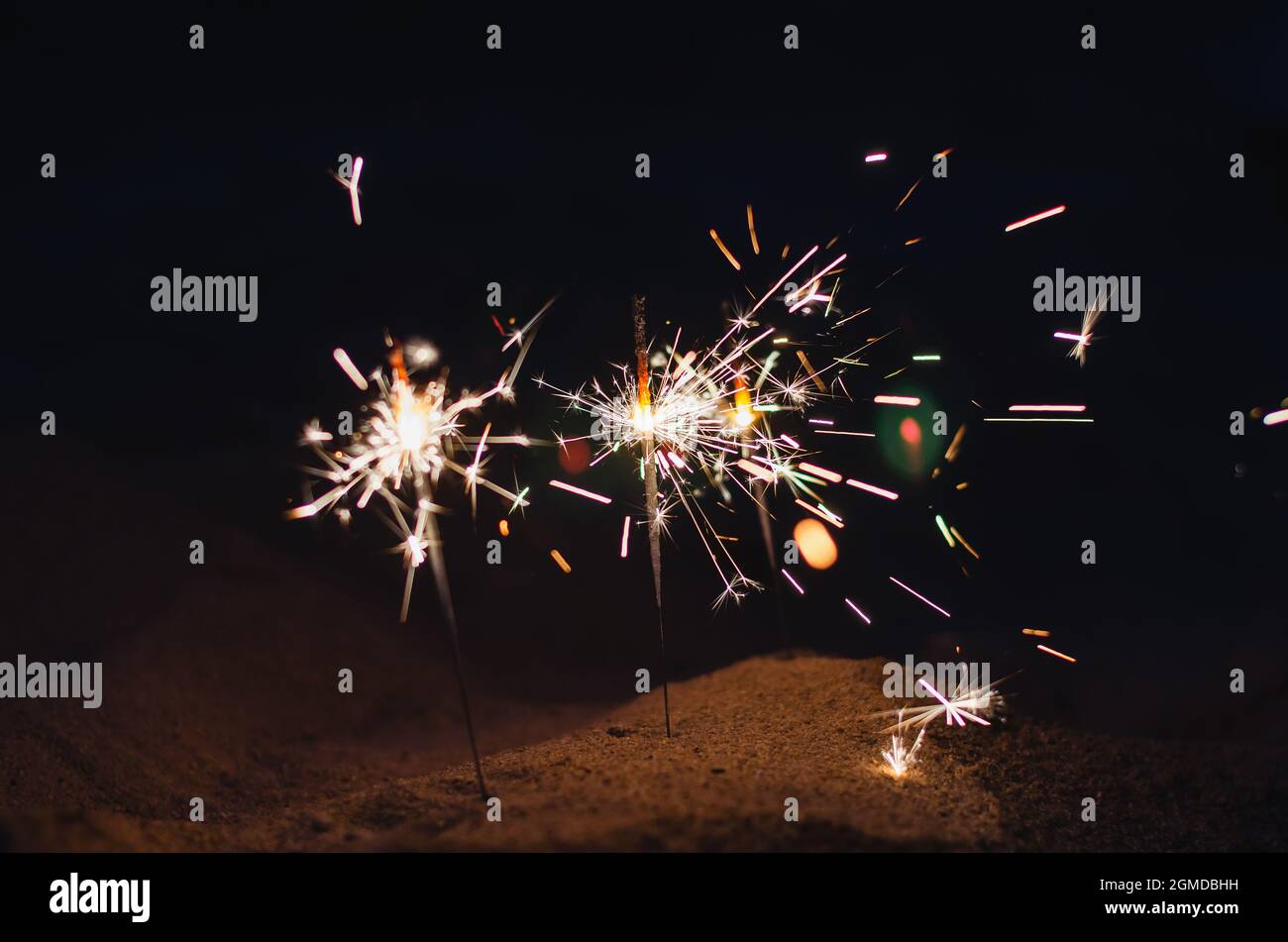 Romantic nighttime background with sparks. Beach sand at night w Stock ...