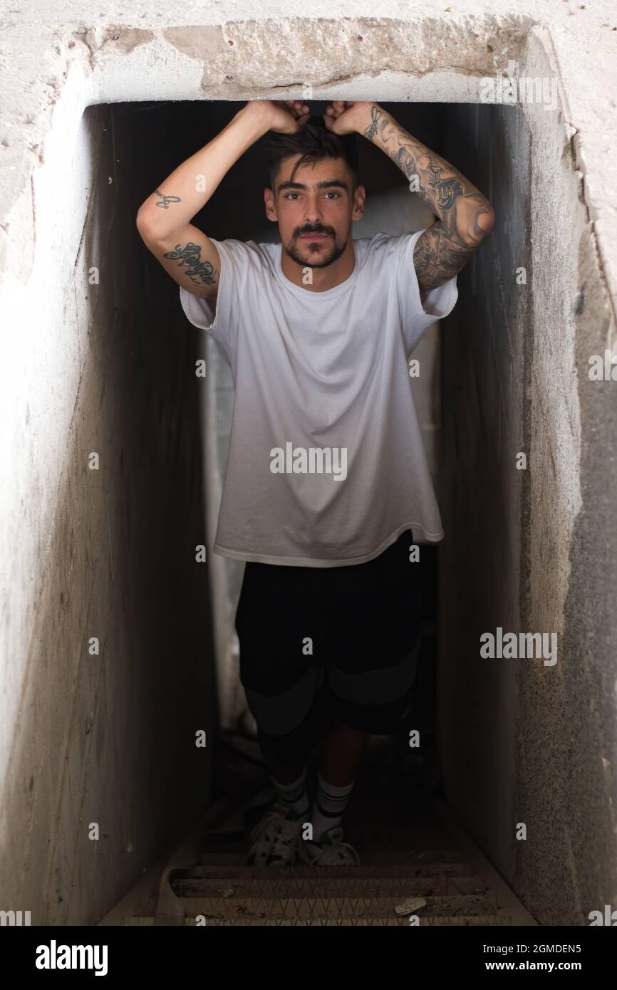 Young man coming out of a basement Stock Photo - Alamy