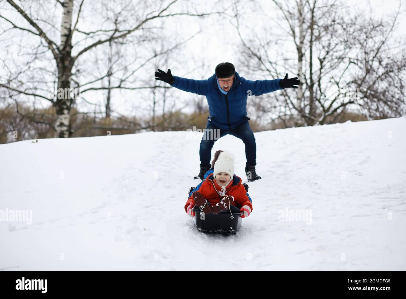 Children in the park in winter. Kids play with snow on the playground ...