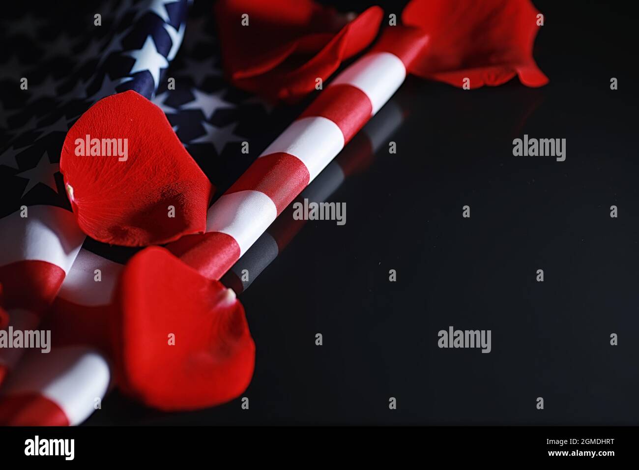 American flag and rose flower on table. Symbol of the United States of ...