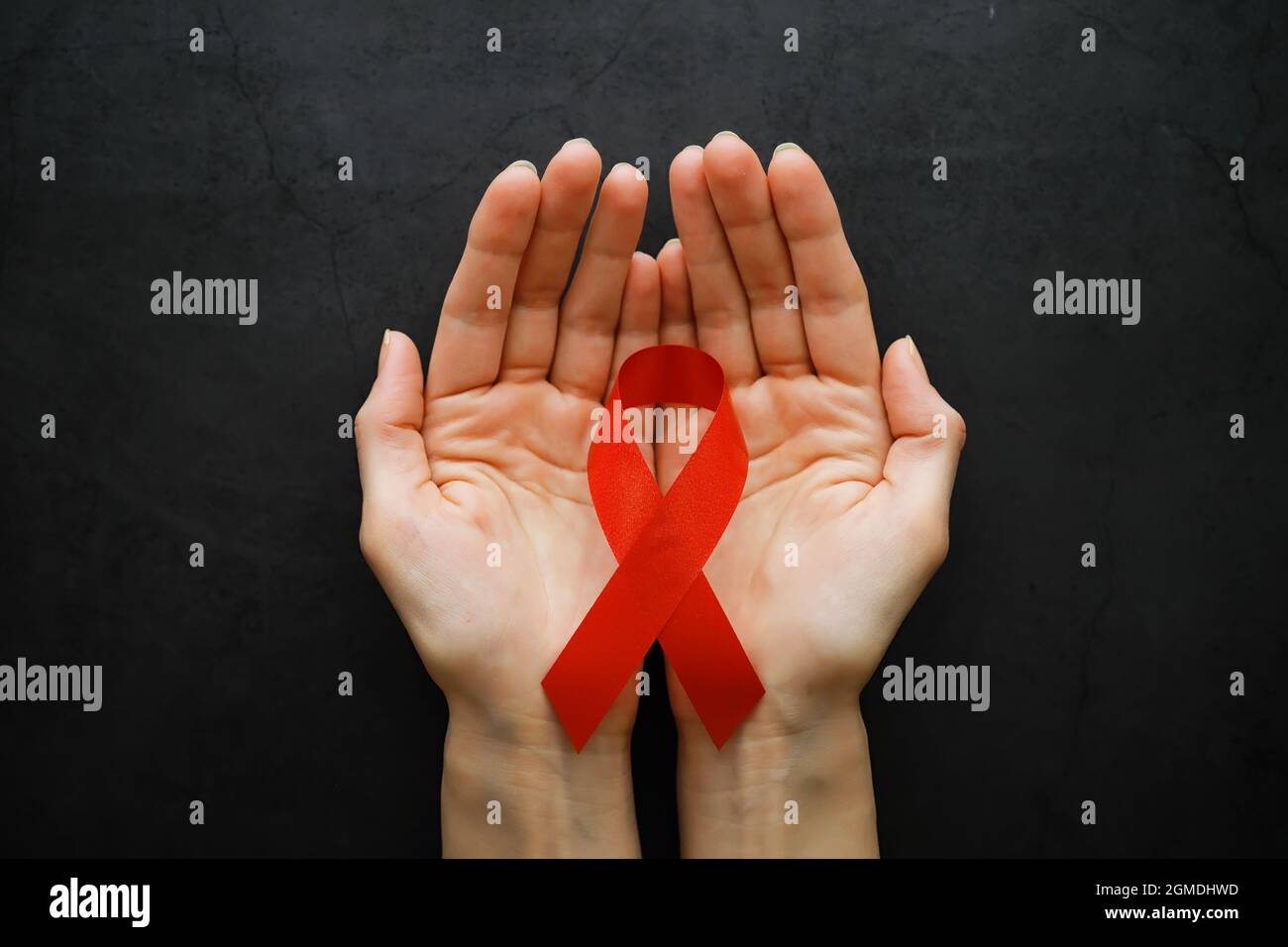 Symbol of human immunodeficiency virus disease. Red ribbon. A helping ...