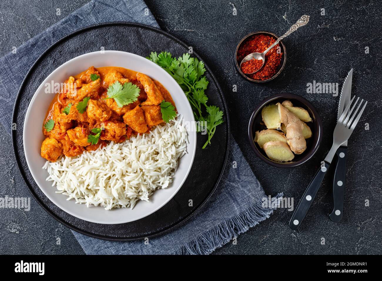 butter chicken with long grain rice and coriander, chicken curry in a ...