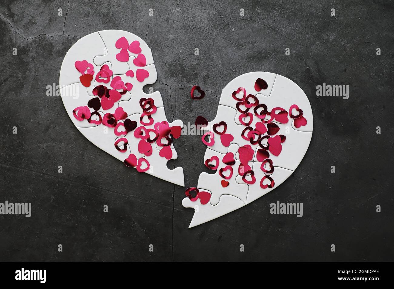 White heart-shaped puzzle. Heart affairs. Undivided love. Broken heart ...