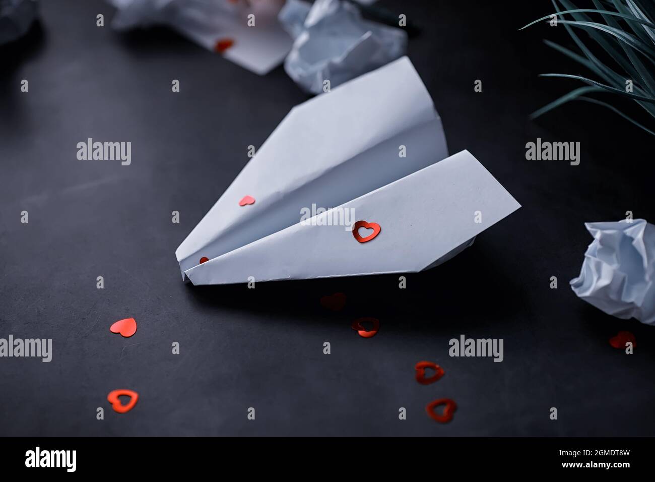 Paper airplane on the table. Origami model on a dark background ...