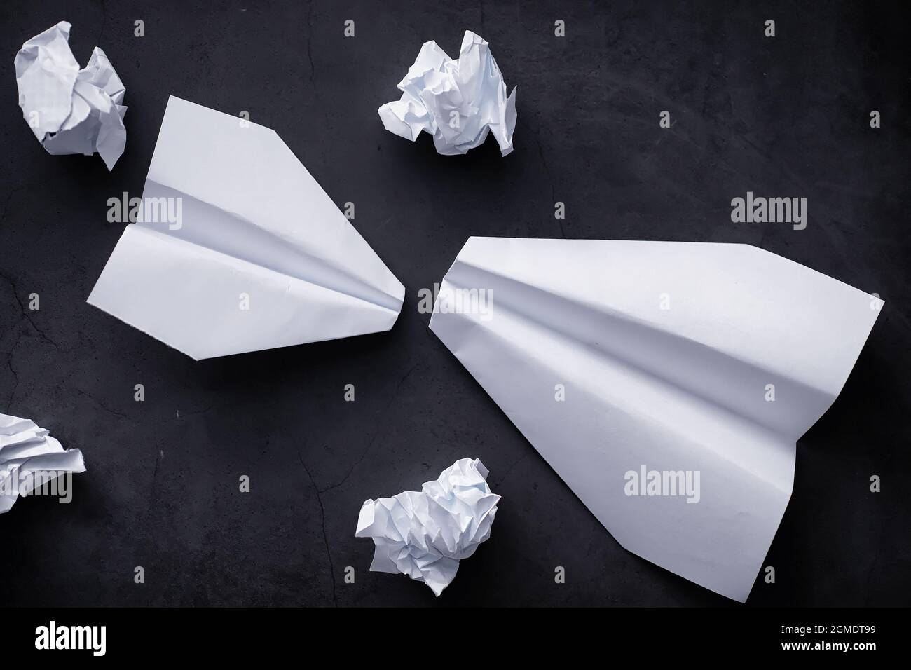 Paper airplane on the table. Origami model on a dark background ...