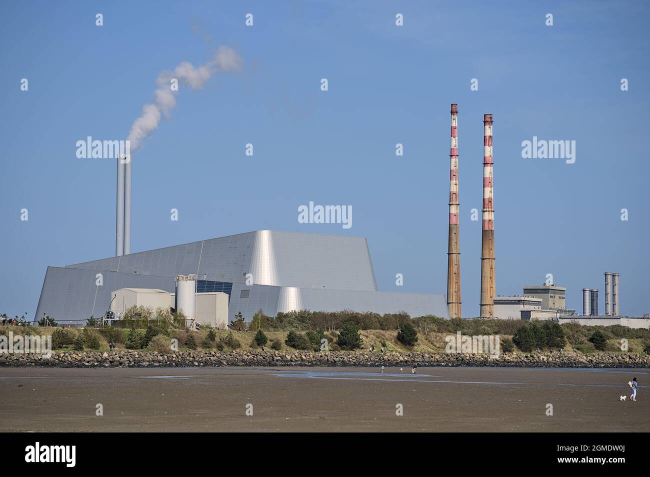 Closeup bright view of iconic Poolbeg CCGT station chimneys and Covanta ...
