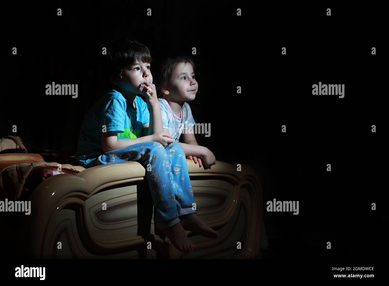 Small children in a dark room watching TV at night Stock Photo - Alamy