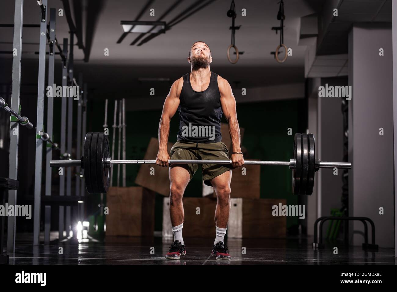 Muscular athlete lifting very heavy barbell Stock Photo - Alamy