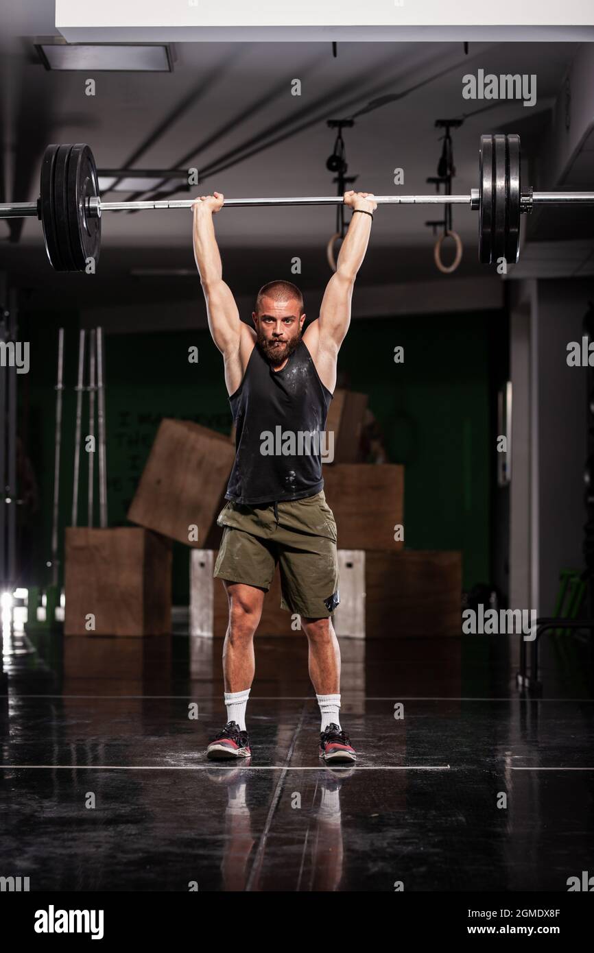 Muscular athlete lifting very heavy barbell Stock Photo - Alamy