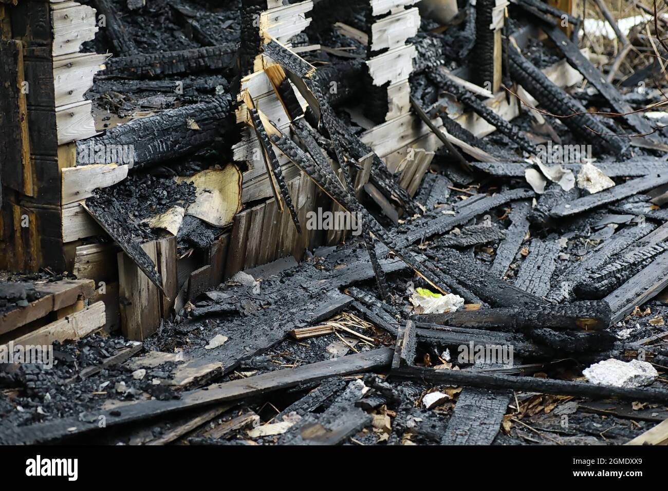 Wooden house after the fire. Coals on the logs. The ashes of the house ...