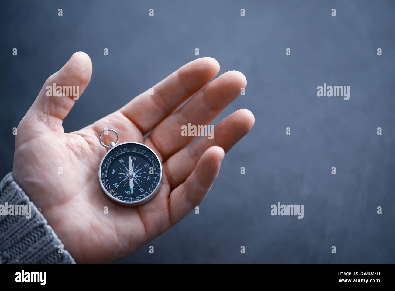 Travel concept. Magnetic compass in the hand. Retro navigator in hand ...