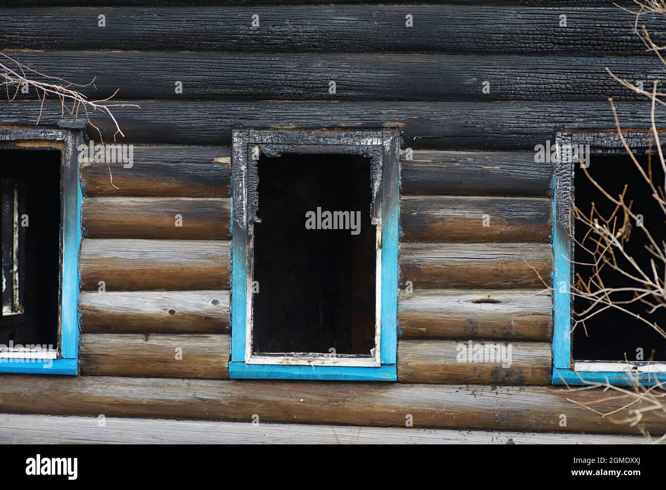 Wooden house after the fire. Coals on the logs. The ashes of the house ...
