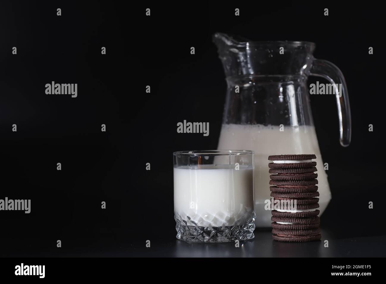 Milk drink in glass. Farm milk and cookies. Delicious snack with cow's ...