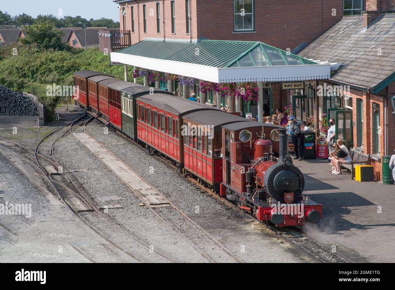 A train waits at Tywyn Wharf Station at the The Talyllyn Railway ...