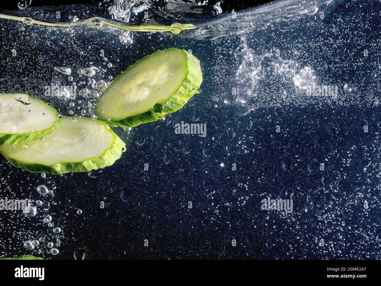 Water drops on ripe cucumber. Fresh vegetables background with copy ...