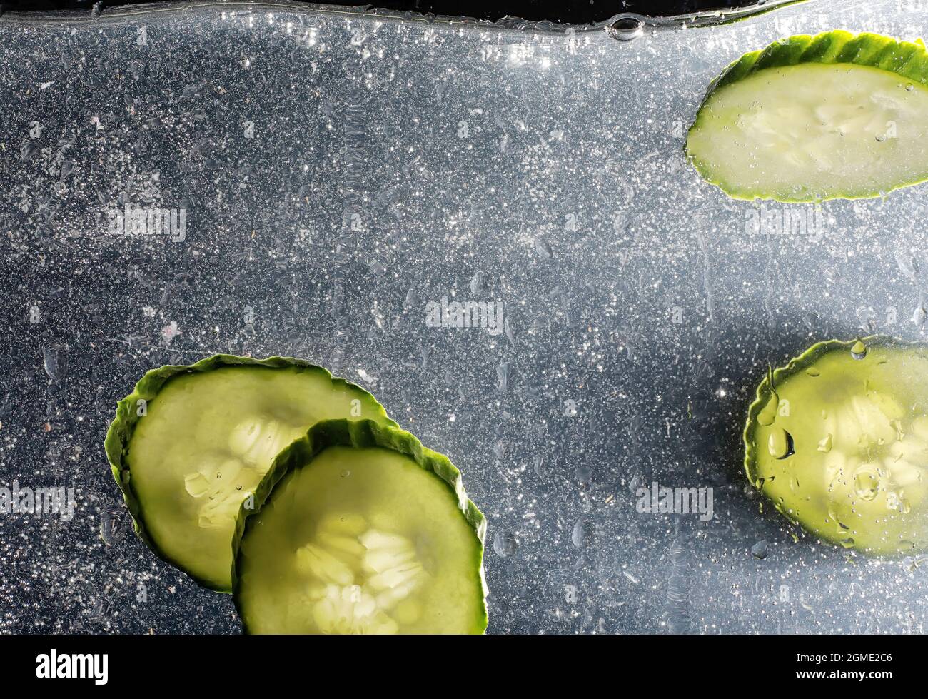 Water drops on ripe cucumber. Fresh vegetables background with copy ...