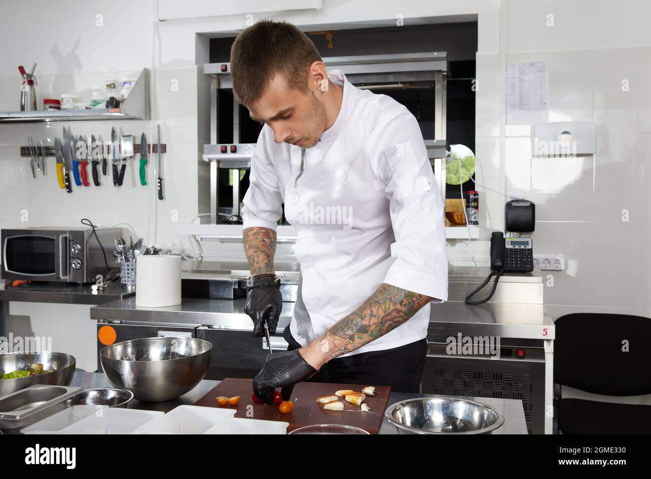 Professional chef cooking in the modern kitchen in hotel restaurant ...