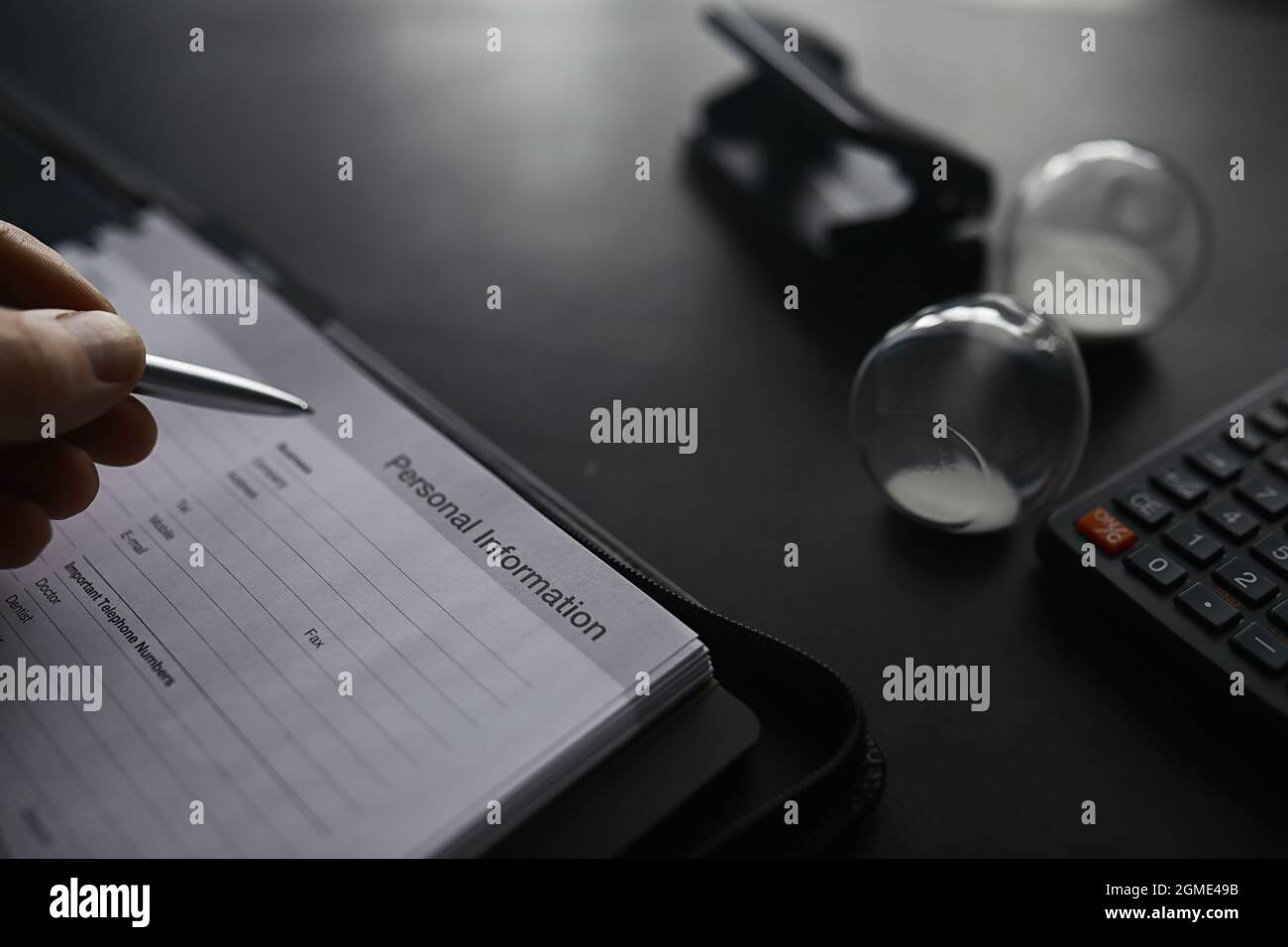 Filling out a form with personal information. Documents in a folder on ...