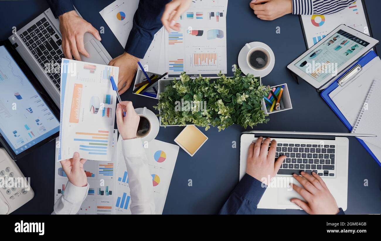 Top view of business teamwork analyzing company accounting paperwork ...