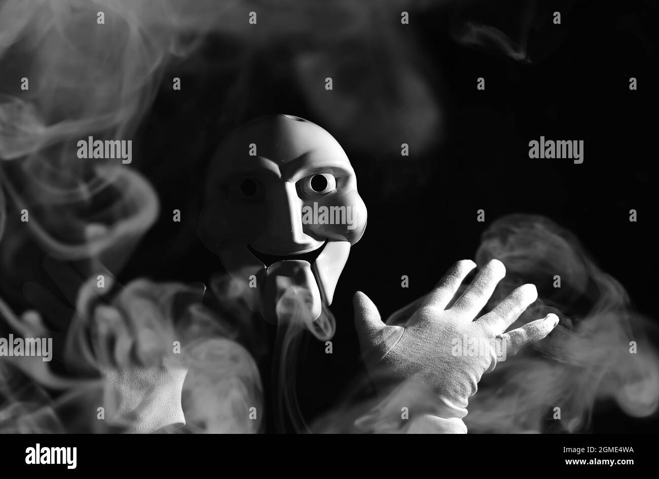 White scary mask on a black background with whites hands Stock Photo ...