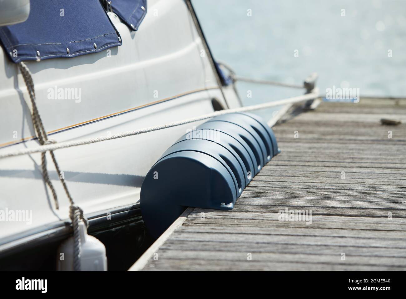 Long pier blue fenders for a boat and dockside for protection. Maritime ...