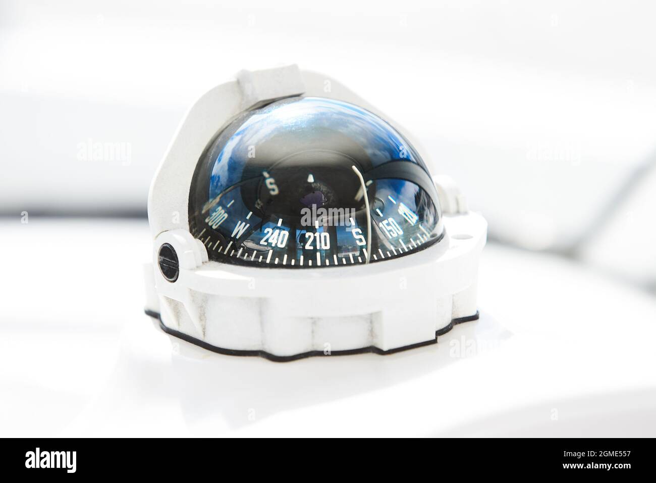 A big compass on a boat showing direction. Harbor background Stock ...