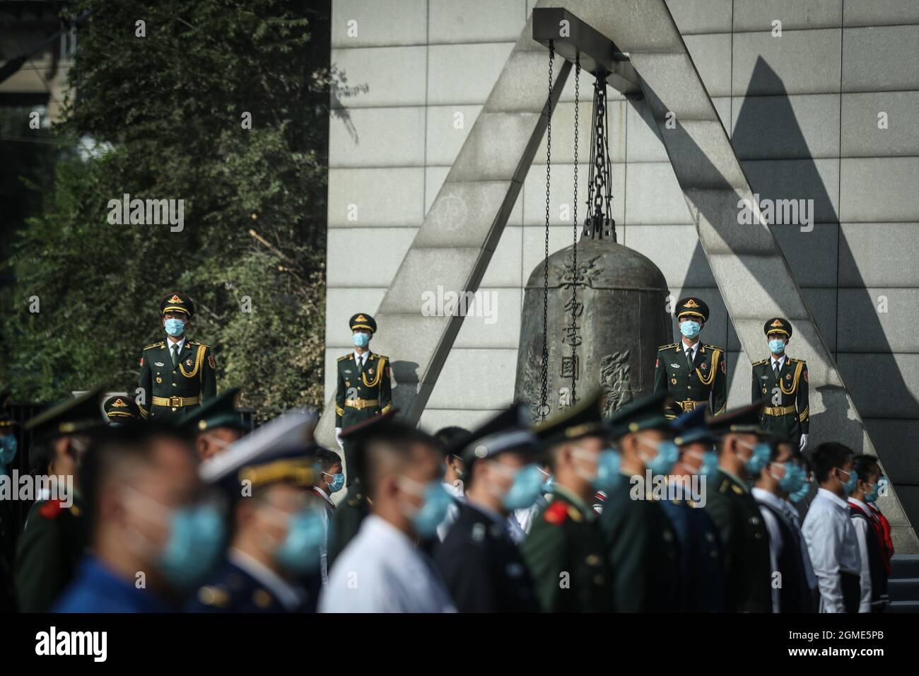 Shenyang, China. 18th Sep, 2021. People attend a bell-tolling ceremony ...