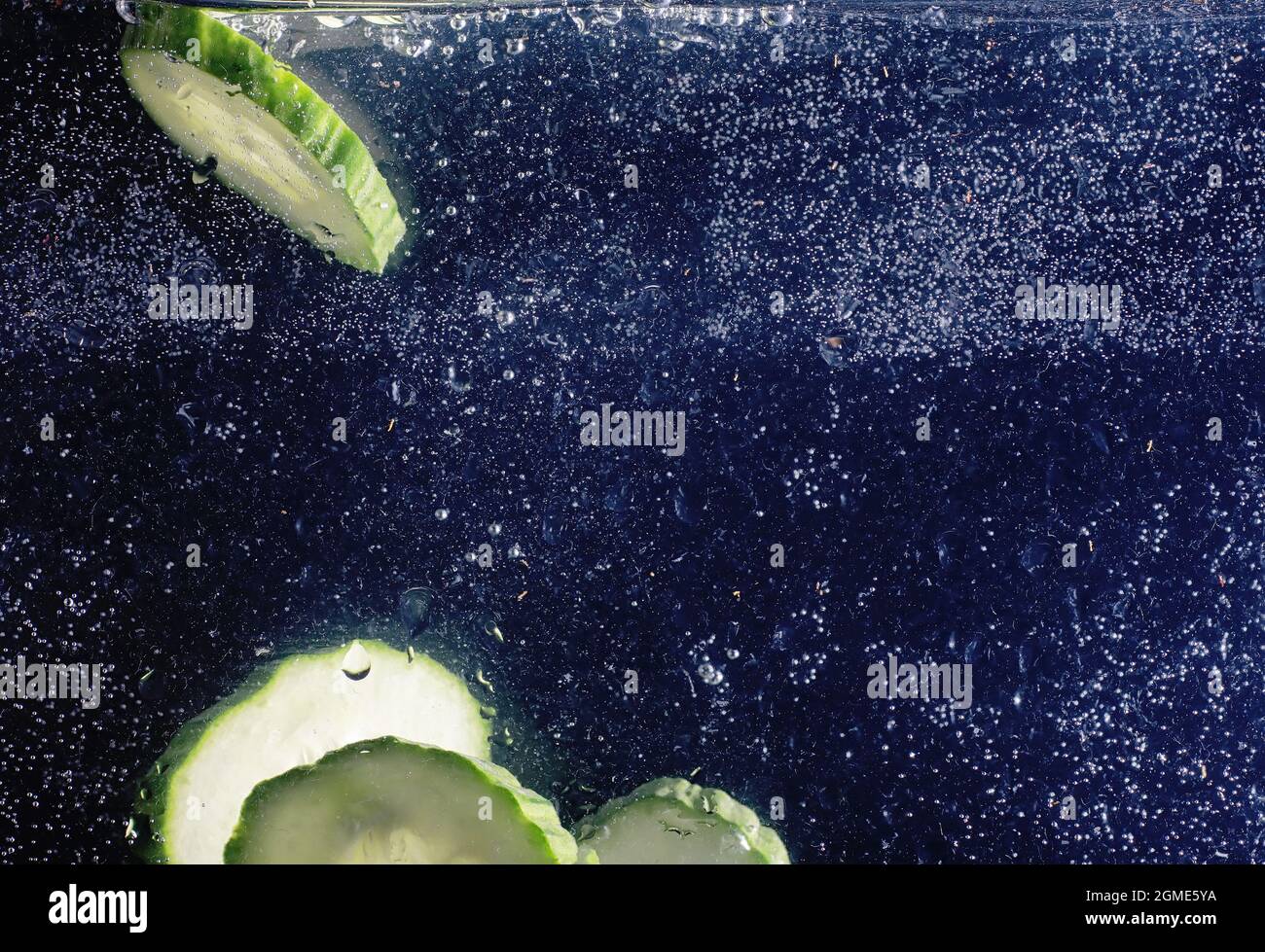 Water drops on ripe cucumber. Fresh vegetables background with copy ...