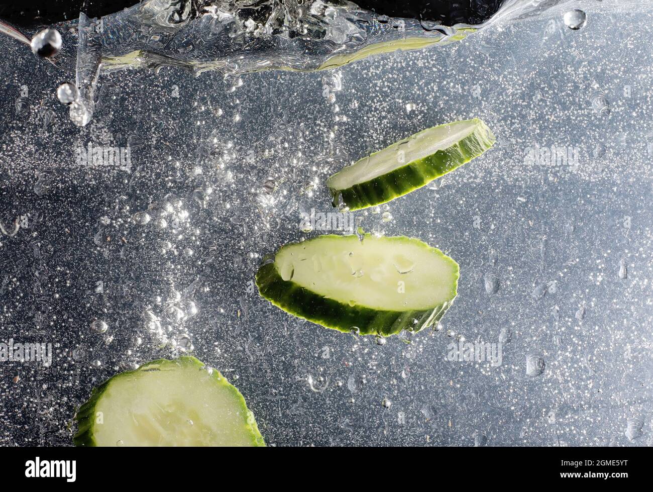 Water drops on ripe cucumber. Fresh vegetables background with copy ...