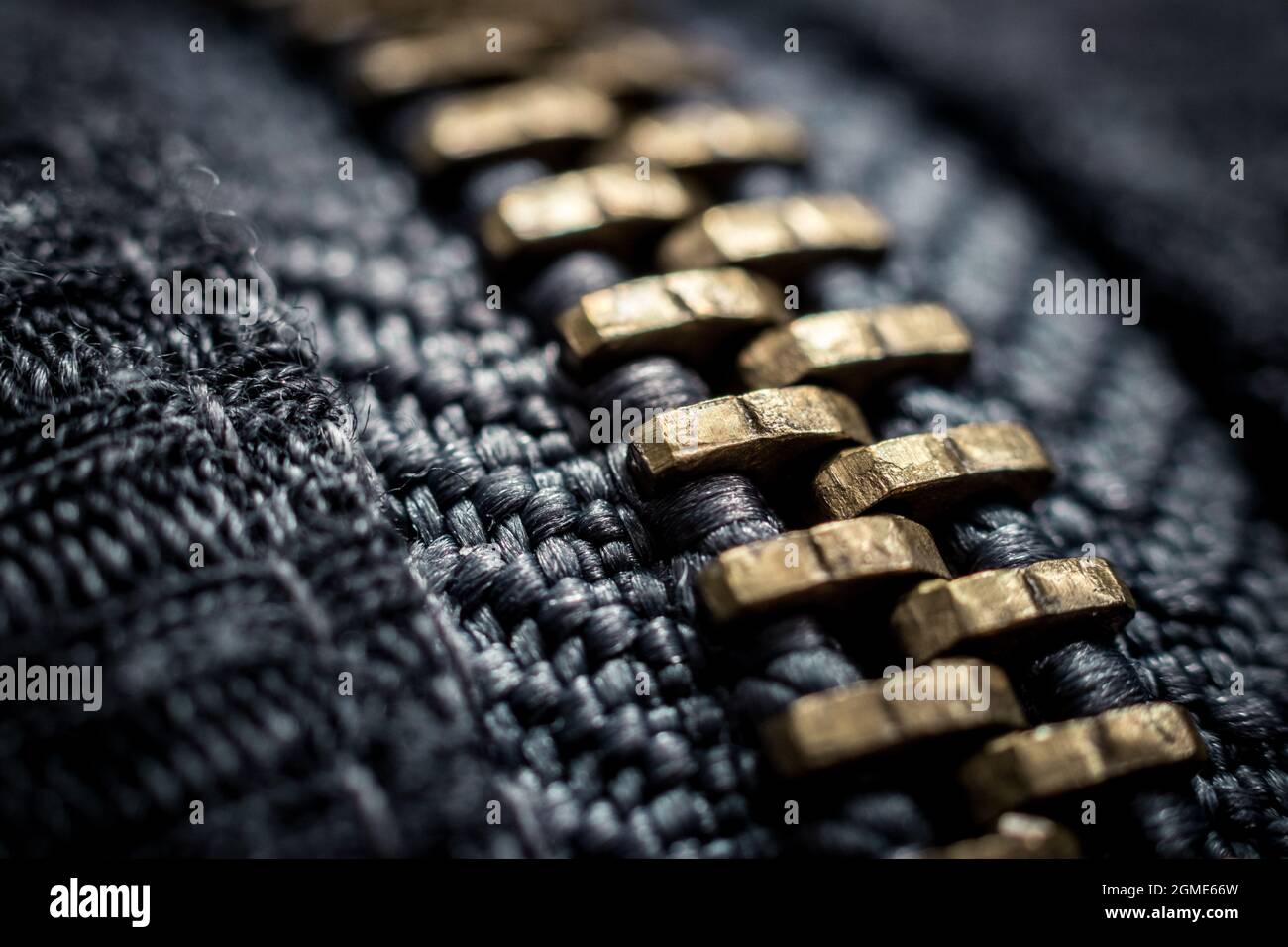 Macrophotography of a zipped golden zipper Stock Photo - Alamy