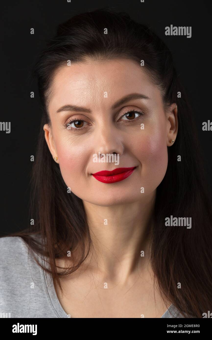 Studio portrait of beautiful woman in 30s with red lips and makeup ...