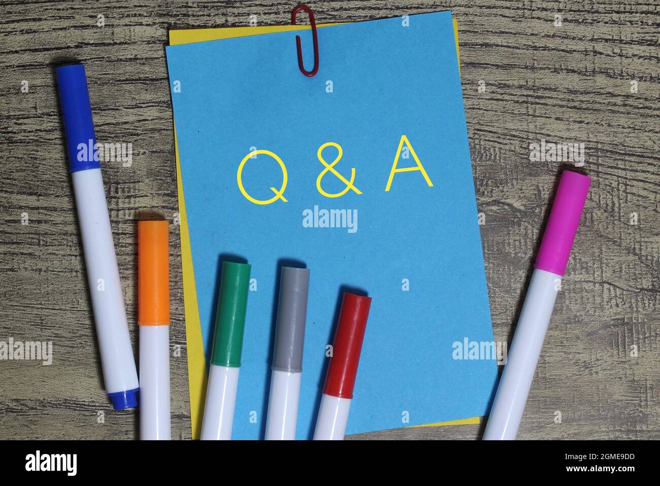 Top view of color pen and color paper with text Q and A. Question and ...